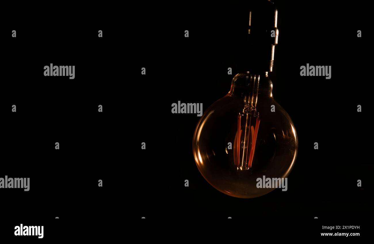 Unlit glass bulb without electricity hanging with warm reflections ...