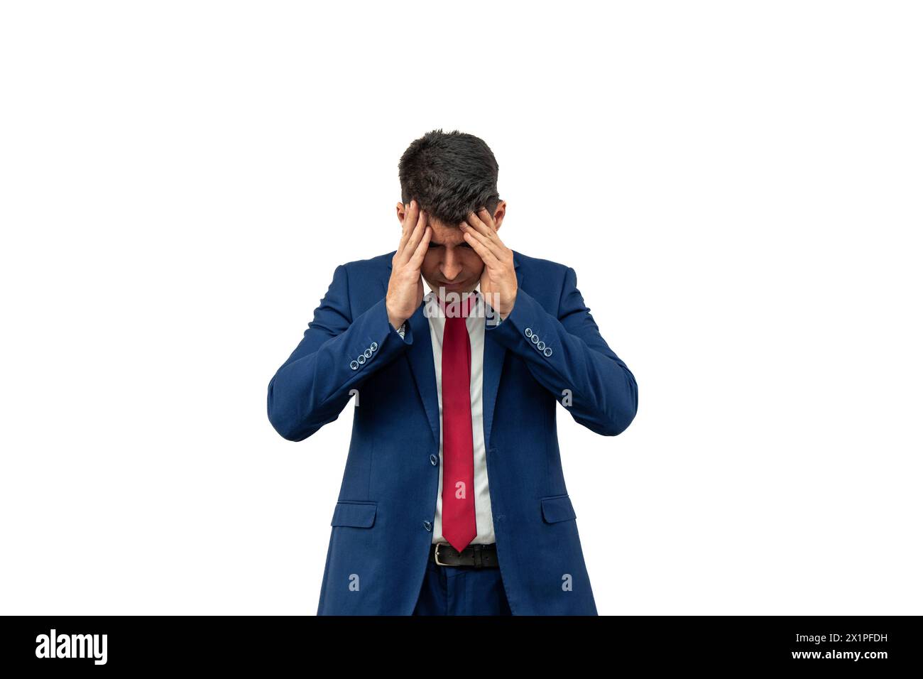 businessman as he gazes downward with a troubled expression, hands ...