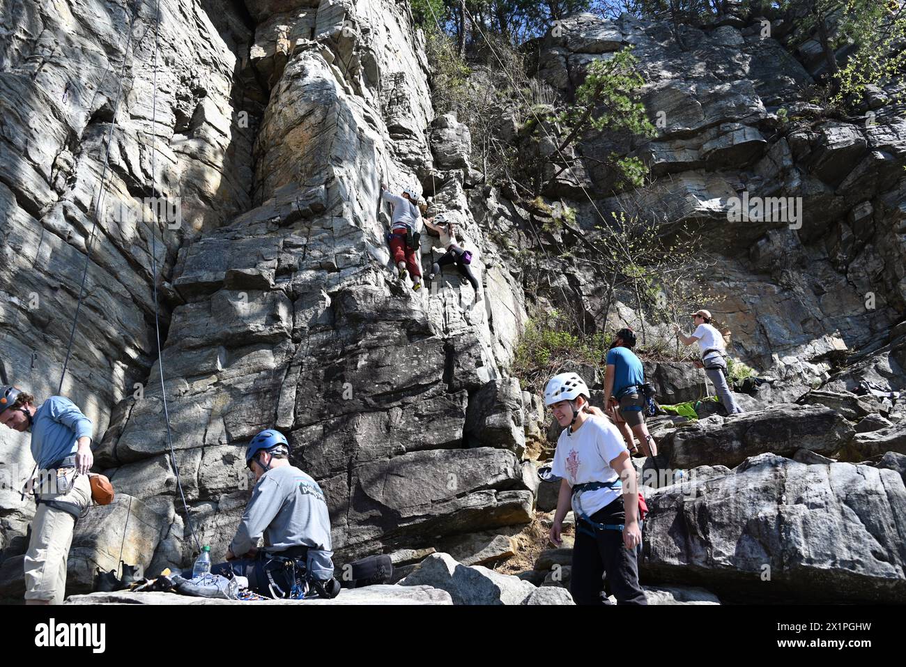 Climbers work their way up a cliff face at Pilot Mountain State Park in ...