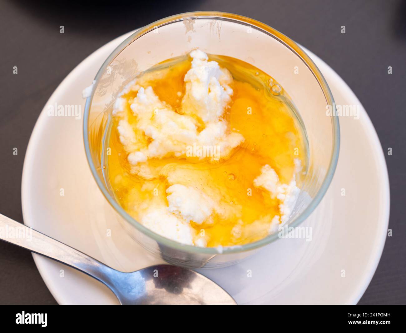 Fresh ship milk mato cheese with honey in glass Stock Photo - Alamy
