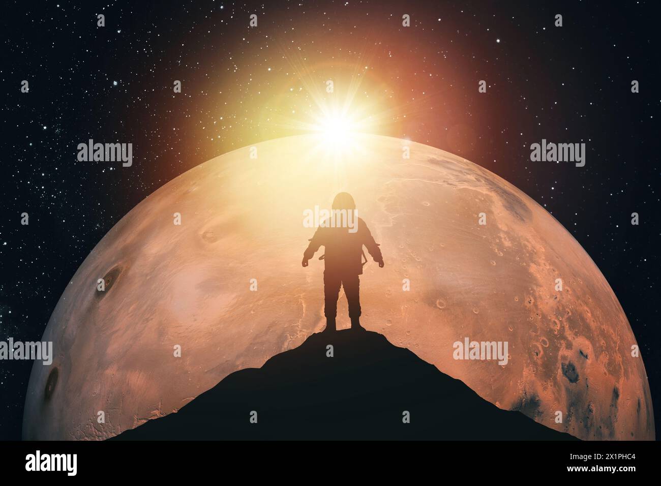 Silhouette of an astronaut on top of a mountain against the background ...