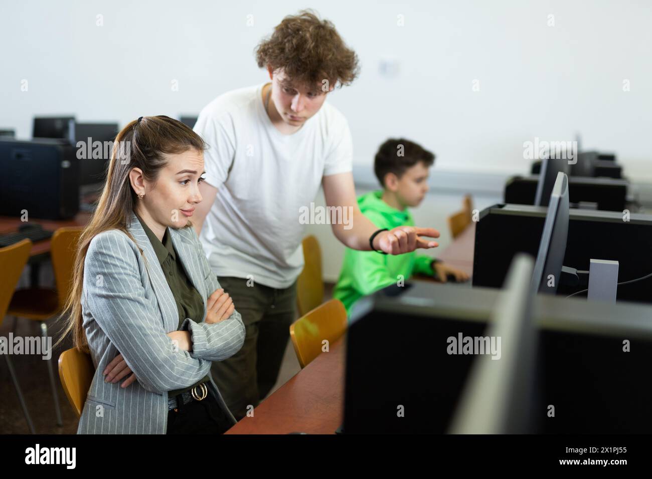 Teacher shows the student how to solve the problem on computer Stock ...
