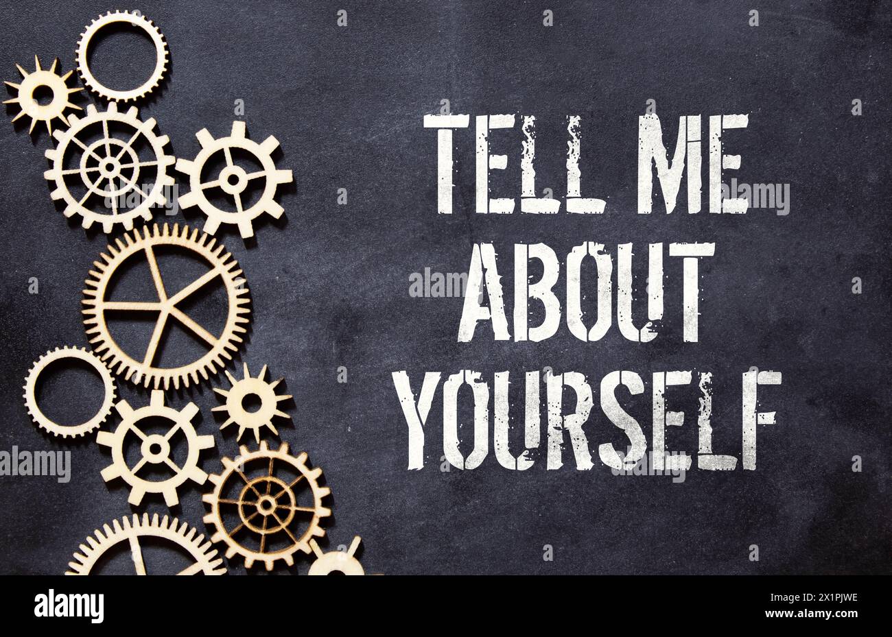 On a white background lies a notebook with words TELL ME ABOUT YOURSELF ...