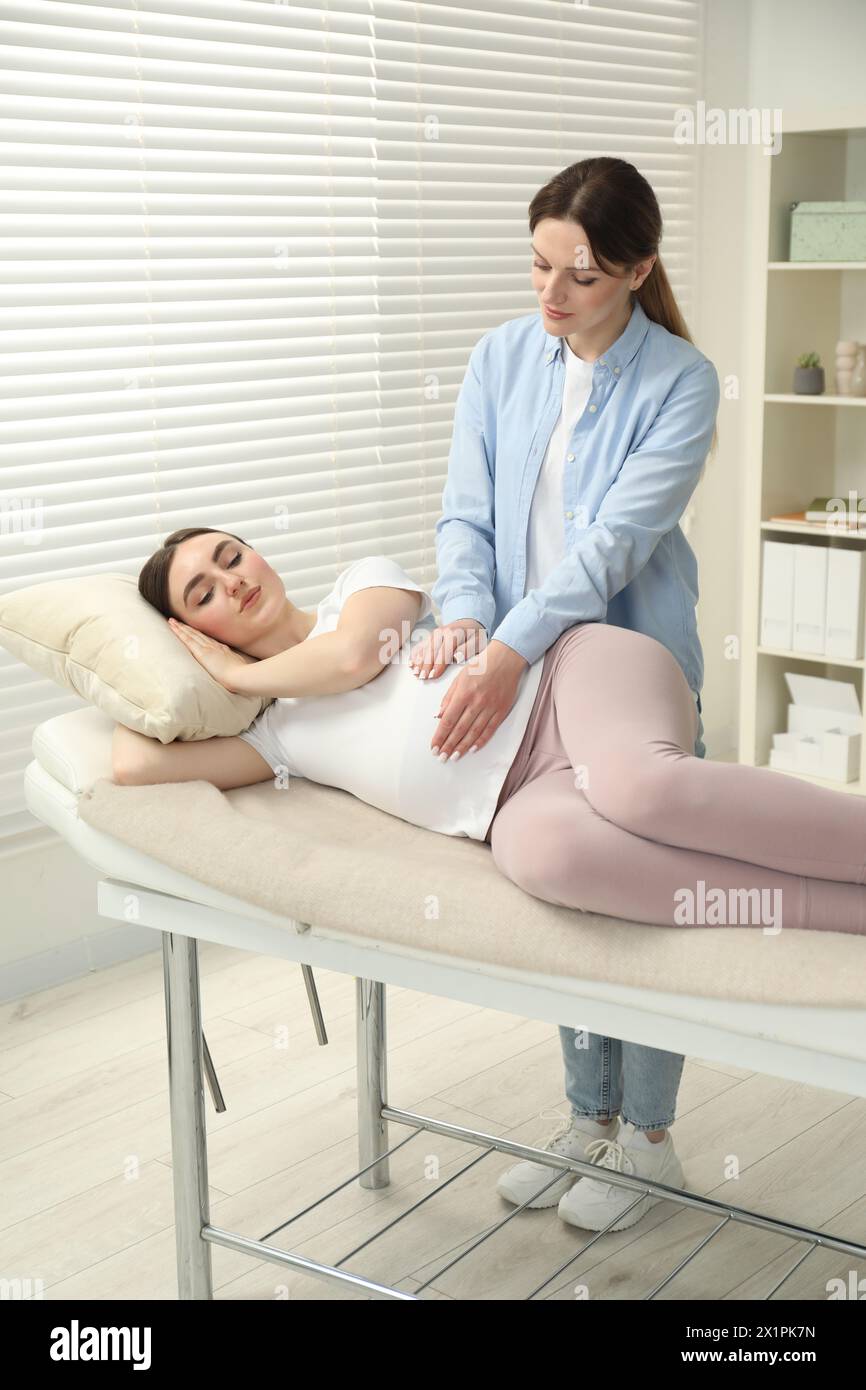 Doula taking care of pregnant woman indoors. Preparation for child birth Stock Photo - Alamy