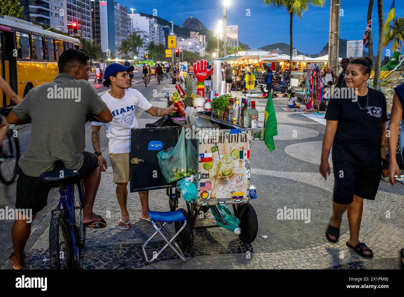 A Man Sells Alcoholic Drinks From A Trolley/Cart On Copacabana Beach ...