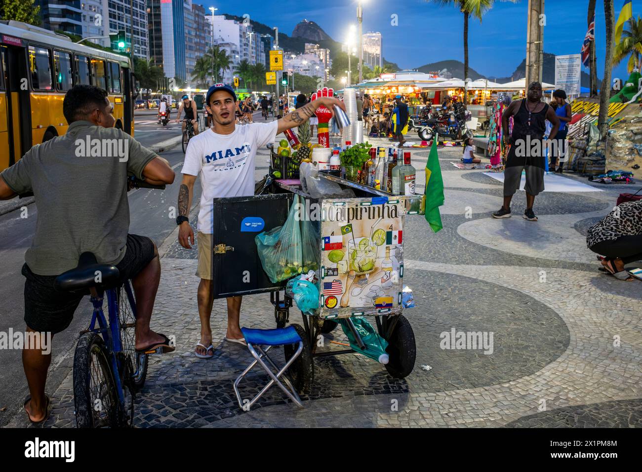A Man Sells Alcoholic Drinks From A Trolley/Cart On Copacabana Beach ...