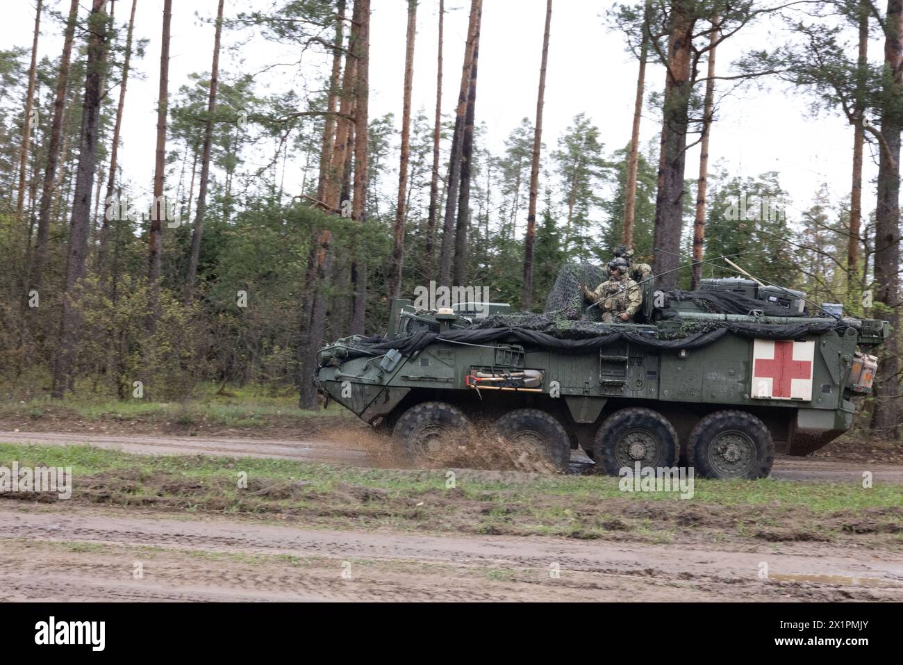 A U.S. Soldier assigned to the 2nd Cavalry Regiment maneuvers a Stryker ...