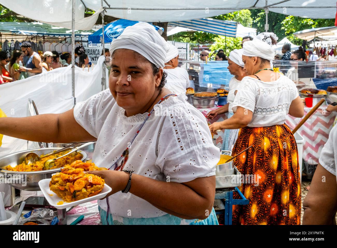 Woman in traditional costume cooking hi-res stock photography and ...