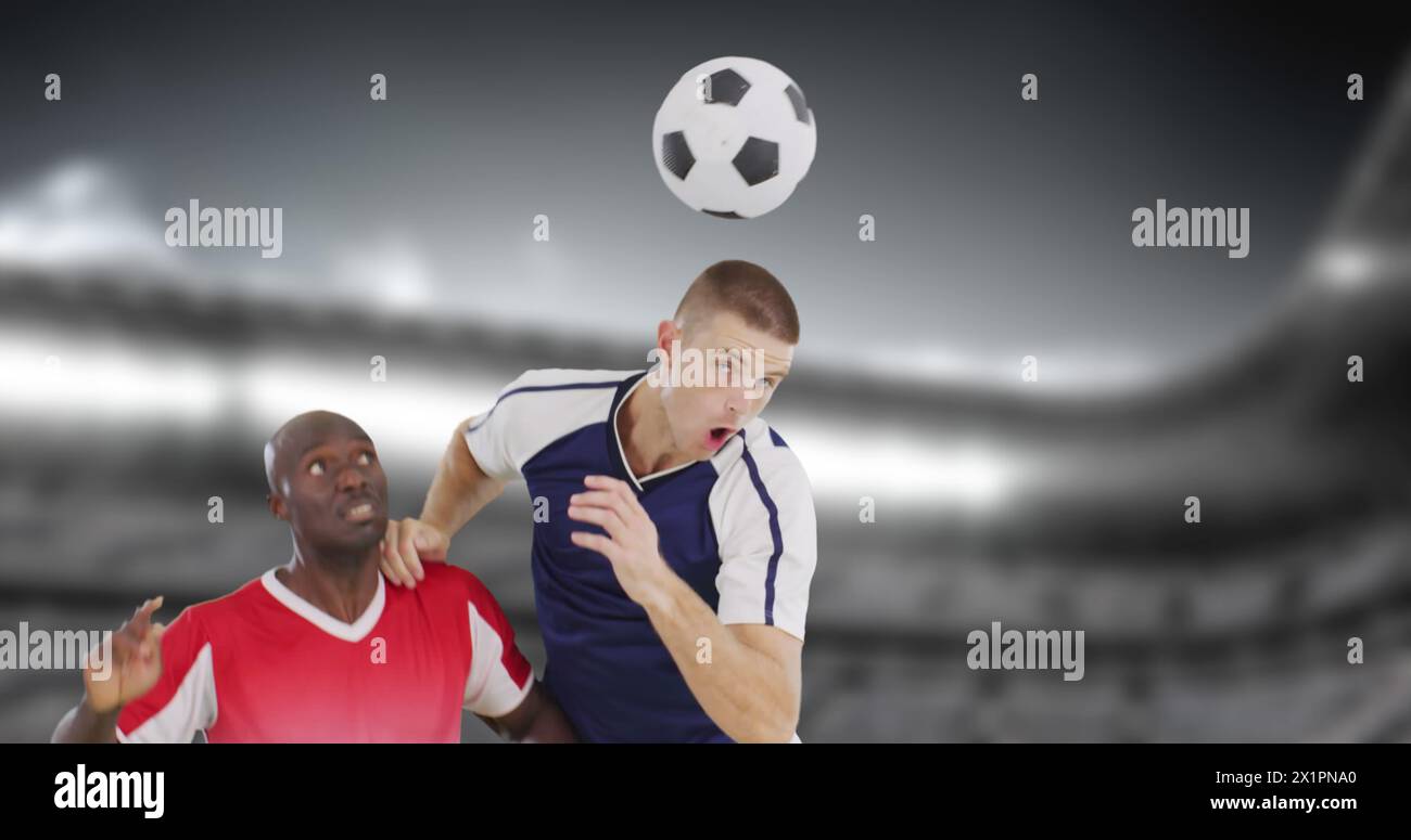 Two soccer players competing for ball mid-air on field Stock Photo - Alamy