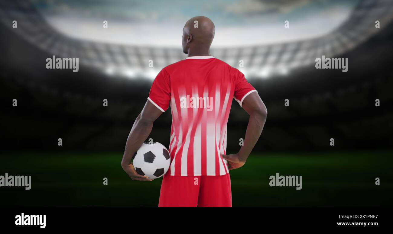 A soccer player holding ball looks at empty stadium Stock Photo - Alamy