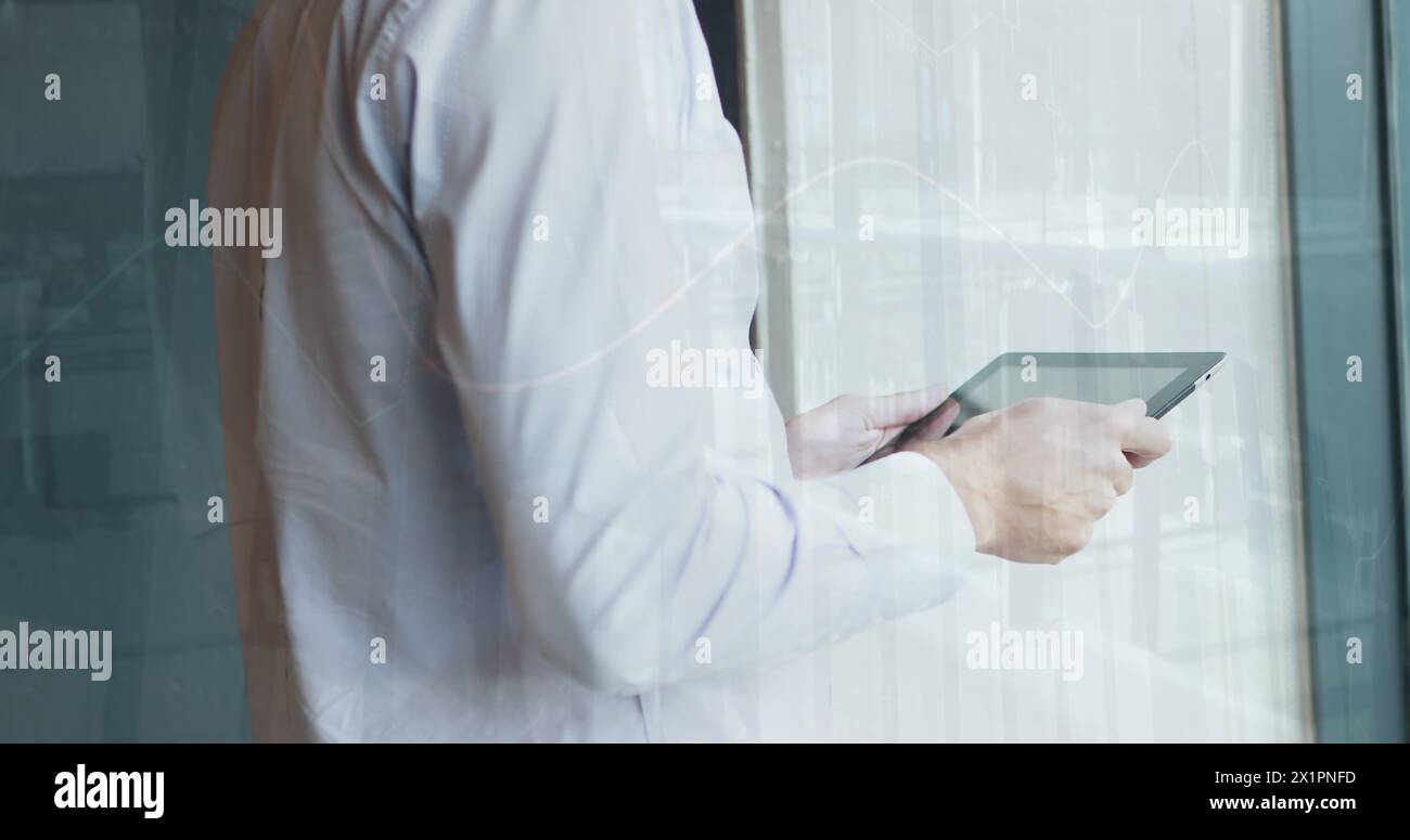 A person holding tablet, looking at screen Stock Photo - Alamy