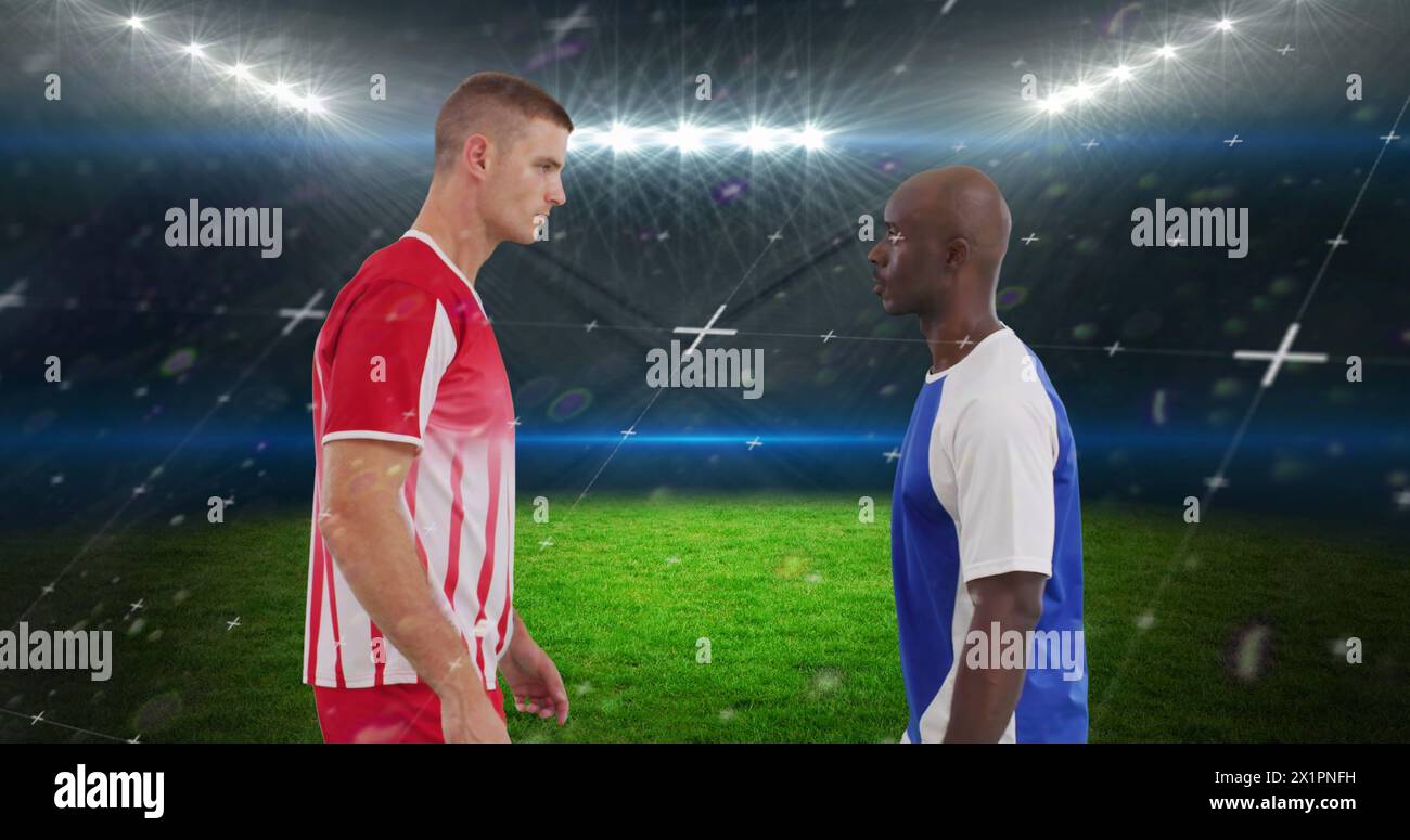 Two soccer players facing each other on field under bright lights Stock ...