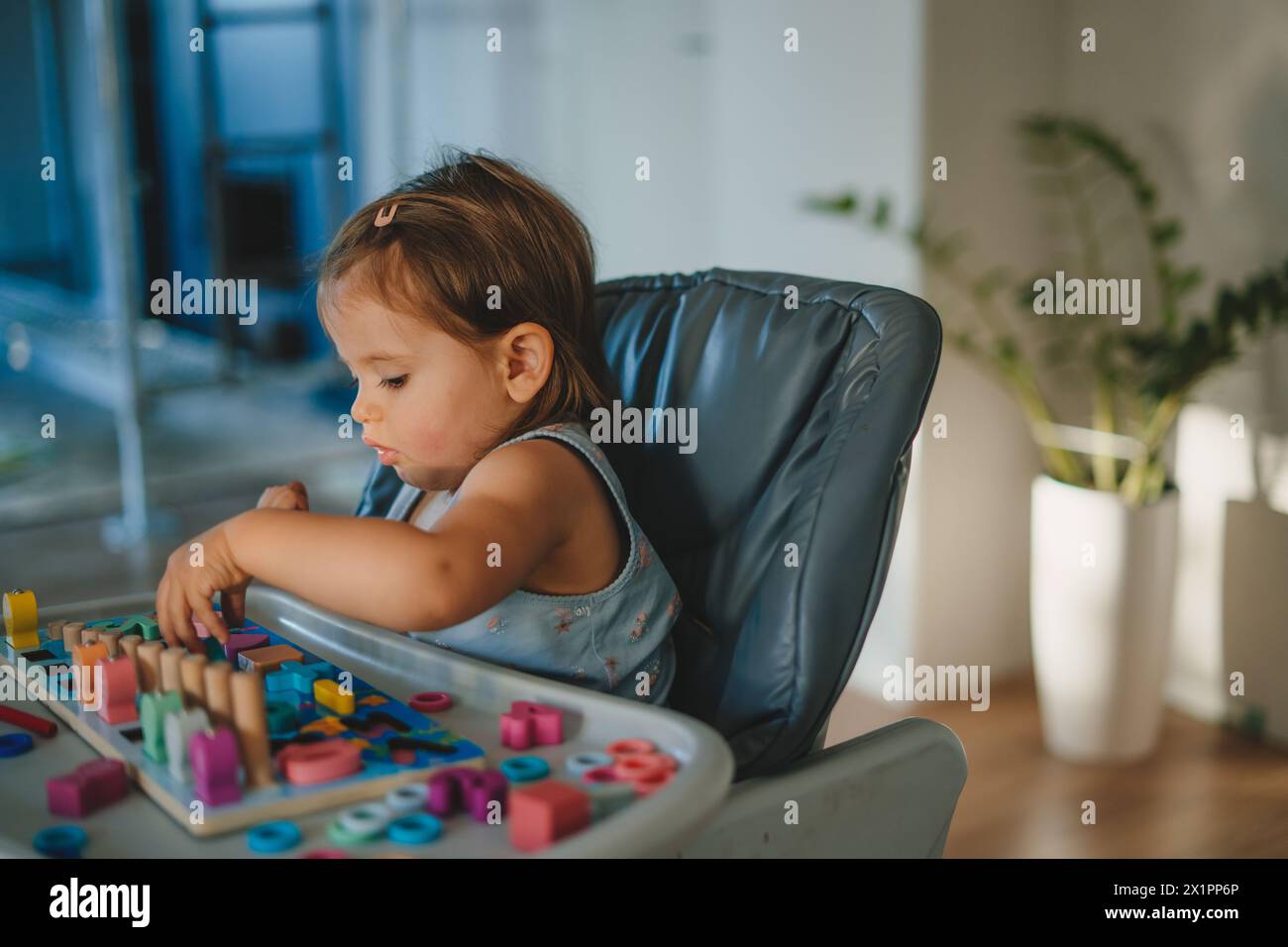 Little kid girl playing with wooden eco friendly alphabet letters board ...
