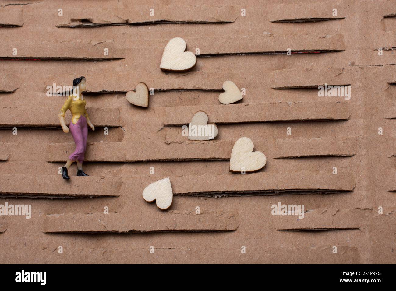 Tiny figurine of man and woman miniature model and heart as love ...