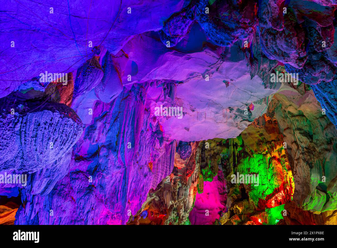 Beautiful illuminated multicolored stalactites from karst Reed Flute ...