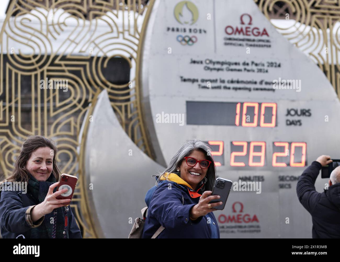 Paris, France. 17th Apr, 2024. Tourists take selfies with a countdown ...