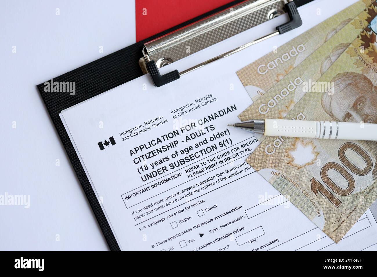 Application for Canadian citizenship for adults on table with pen and ...