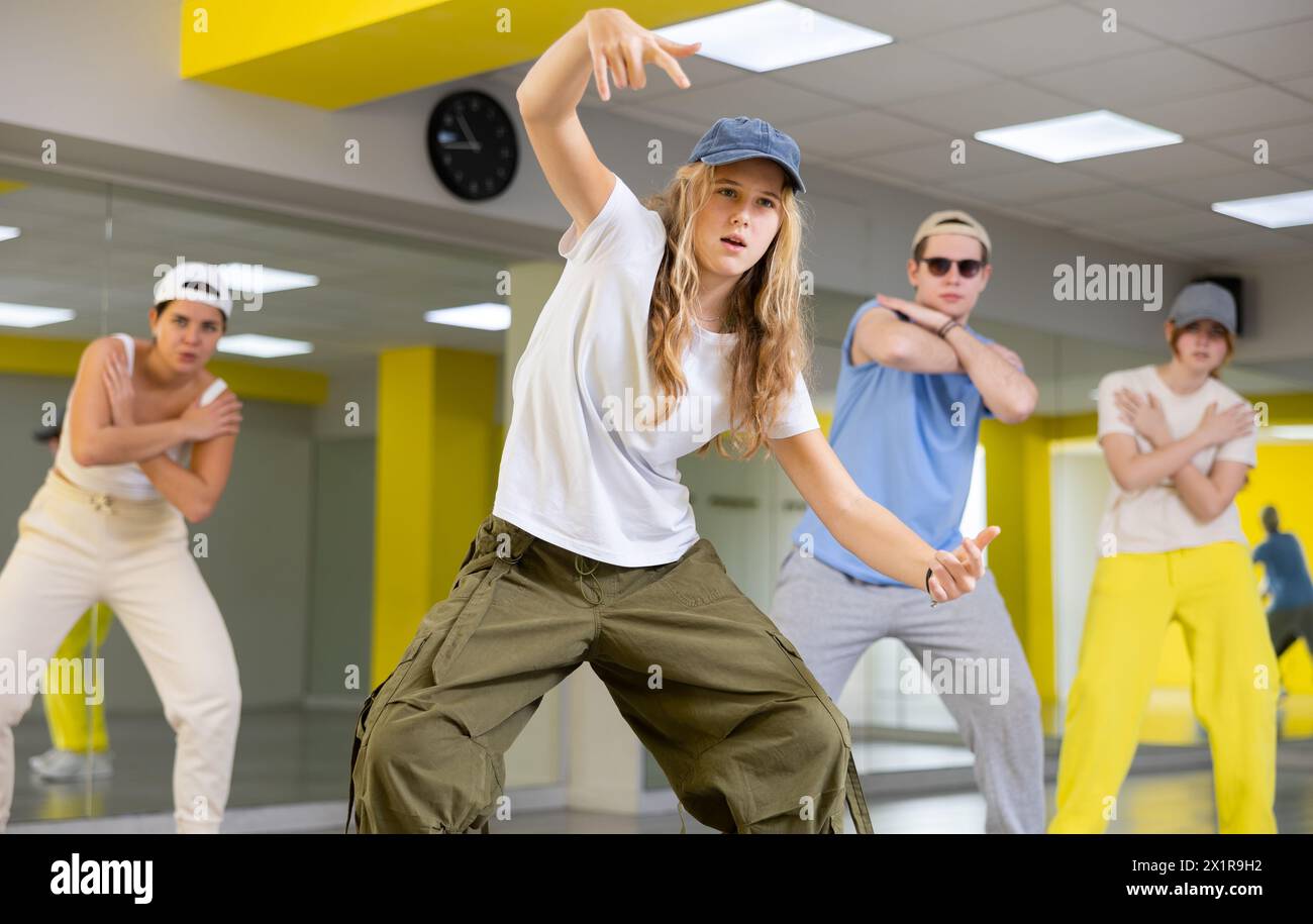 Teen girl in cap dancing modern dances Stock Photo - Alamy