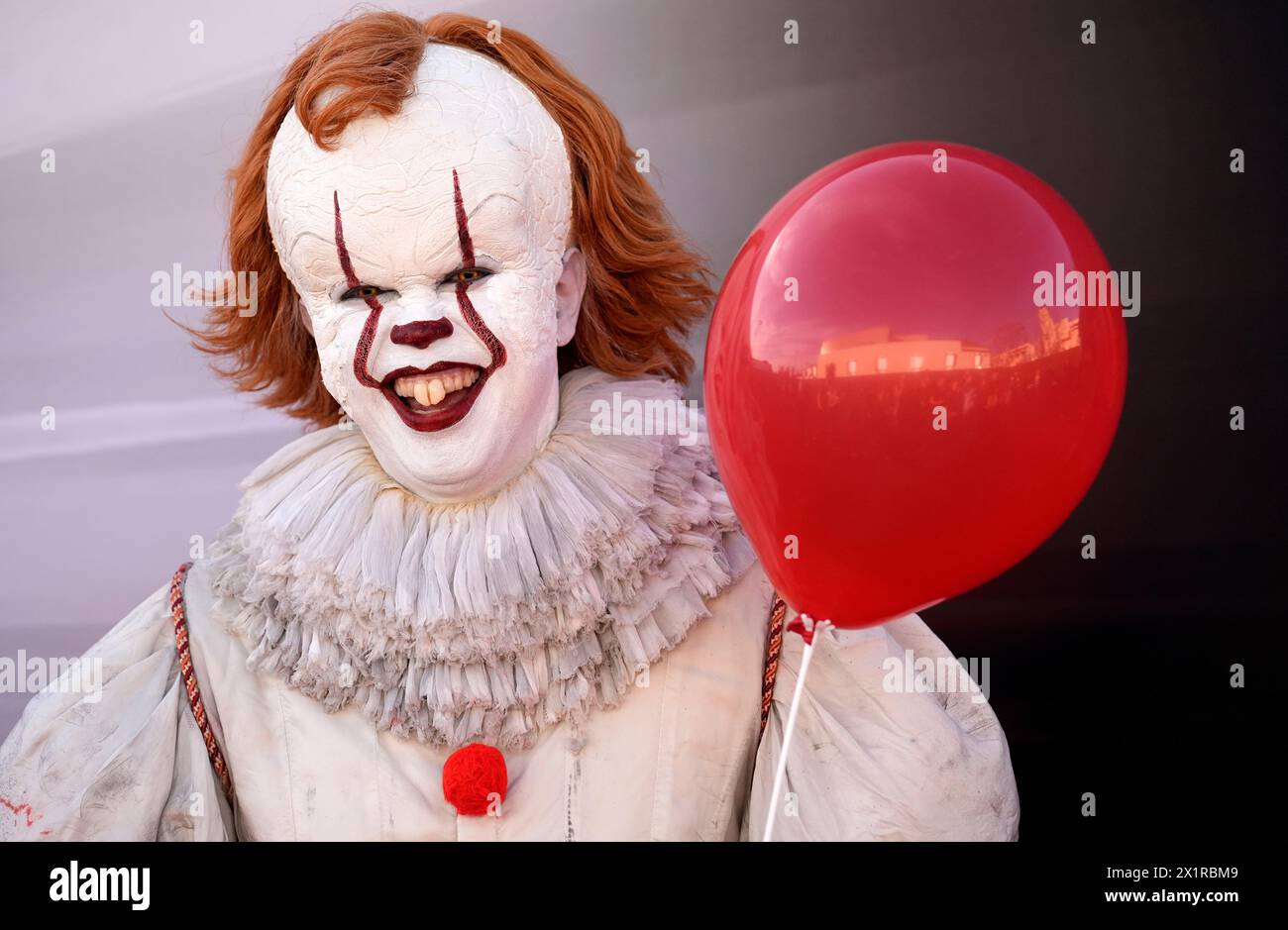 An actor playing "Pennywise" from the horror film "It" poses at the ...
