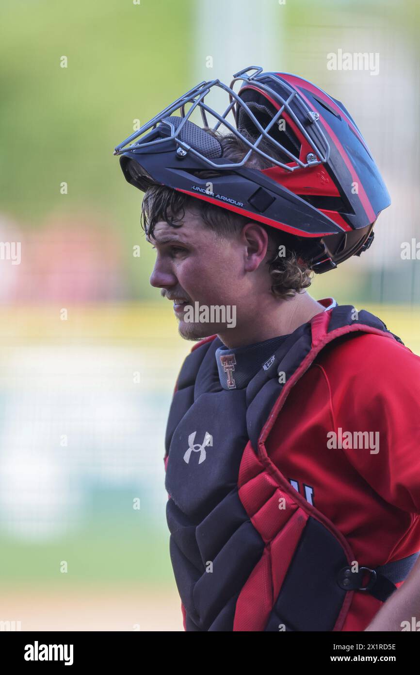 April 17, 2024: Red Raiders catcher Kevin Bazzell #4 lifts up his mask ...