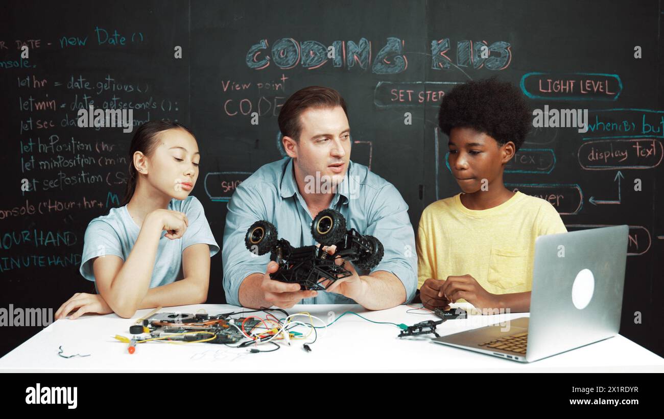 Teacher pick car model while happy student inspect robotic construction ...