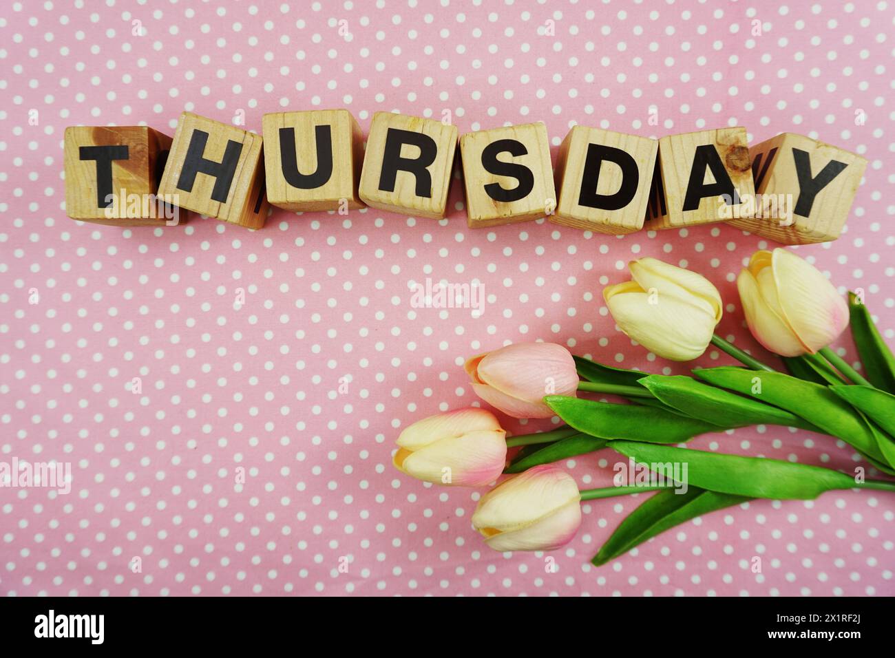 Thursday alphabet letters with tulip flowes bouquet top view on polka ...
