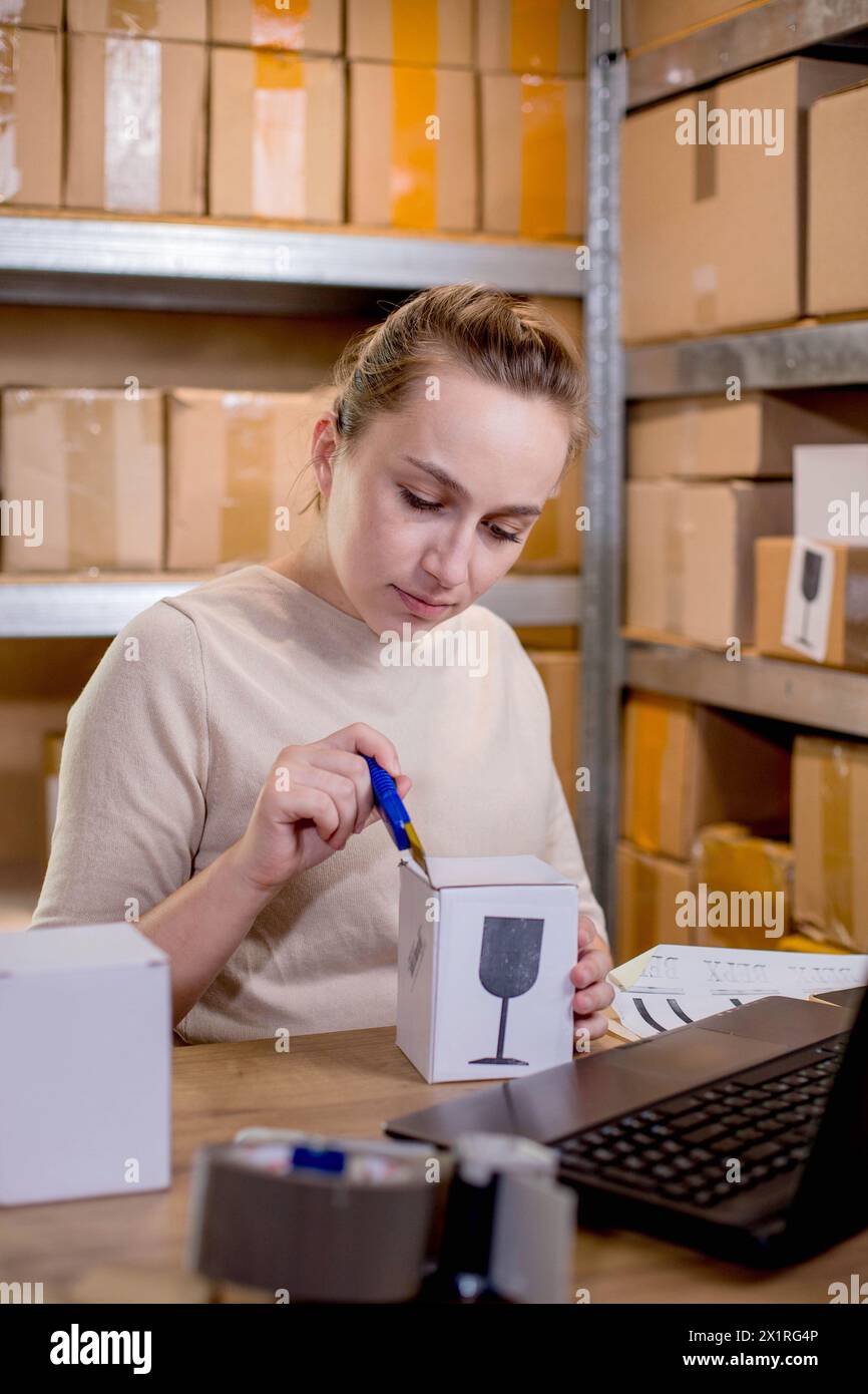 Woman delivering fragile box in hi-res stock photography and images - Alamy