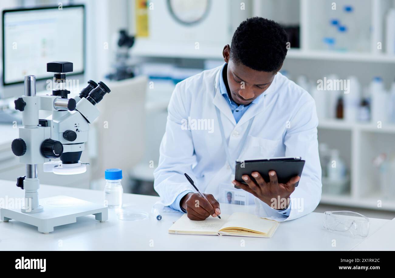 Science, researcher and black man writing, tablet and notes for ...