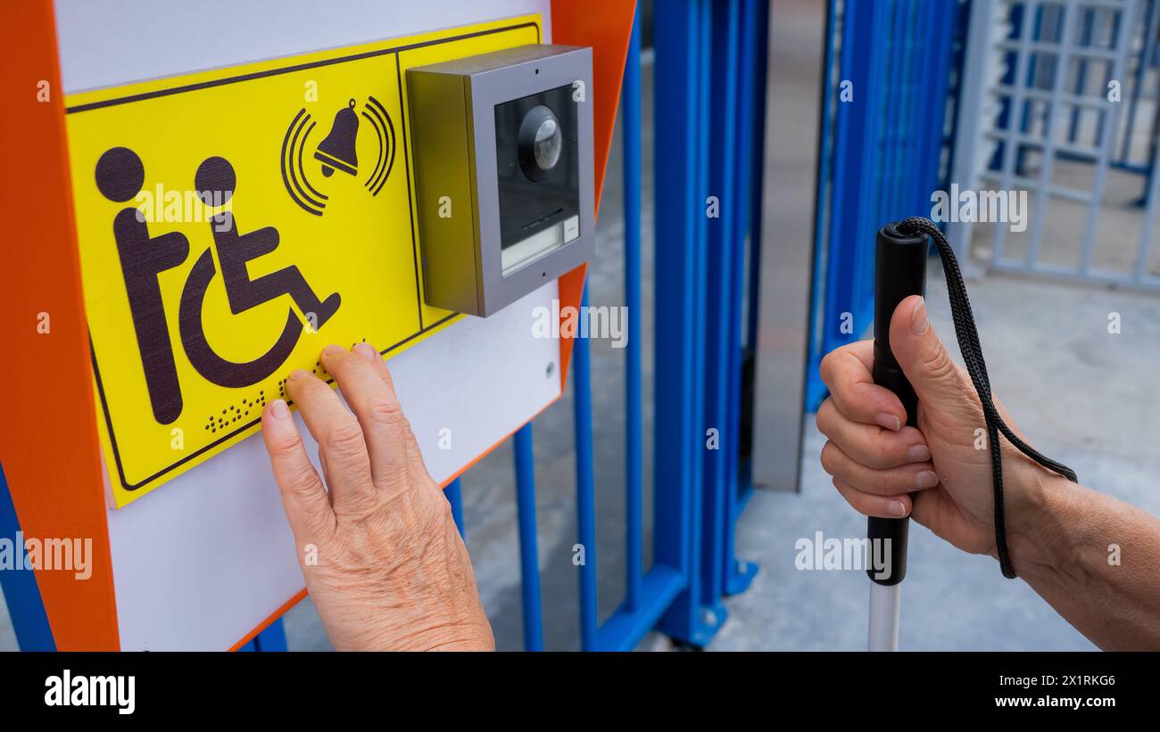 Close-up of the hands of a blind elderly woman reading a text in ...