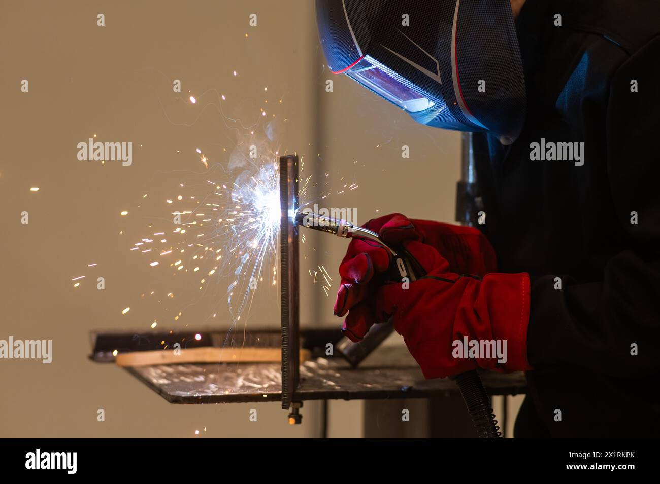 A man learns the craft of welding on a sample Stock Photo - Alamy