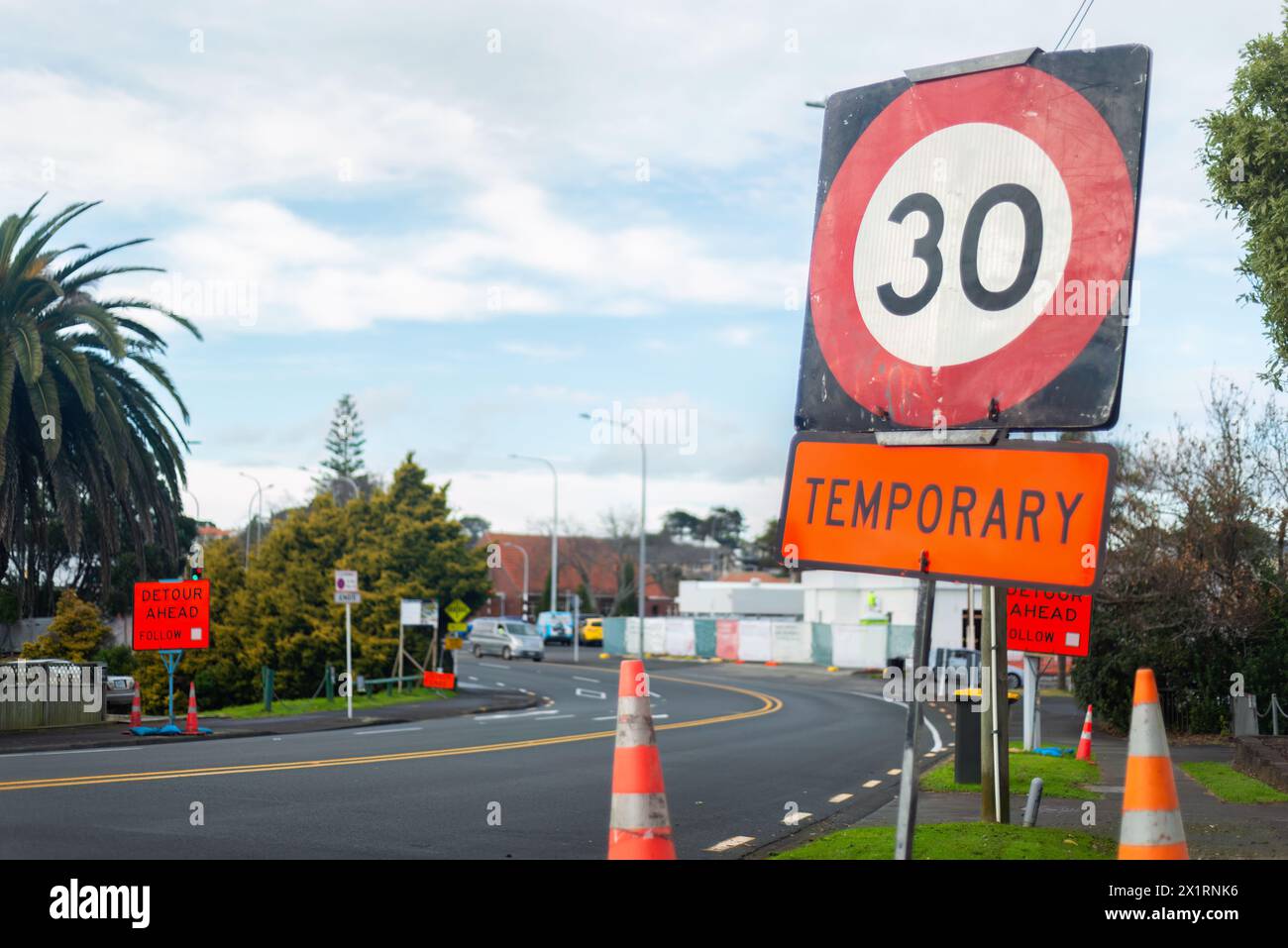 30km per hour road speed sign and orange traffic cones on the street ...