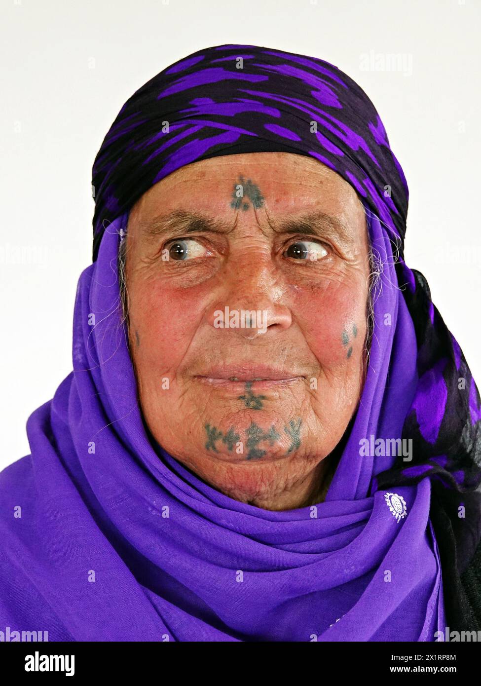 A Yazidi woman with traditional tattoos (Deq in Kurdish) on her face is ...