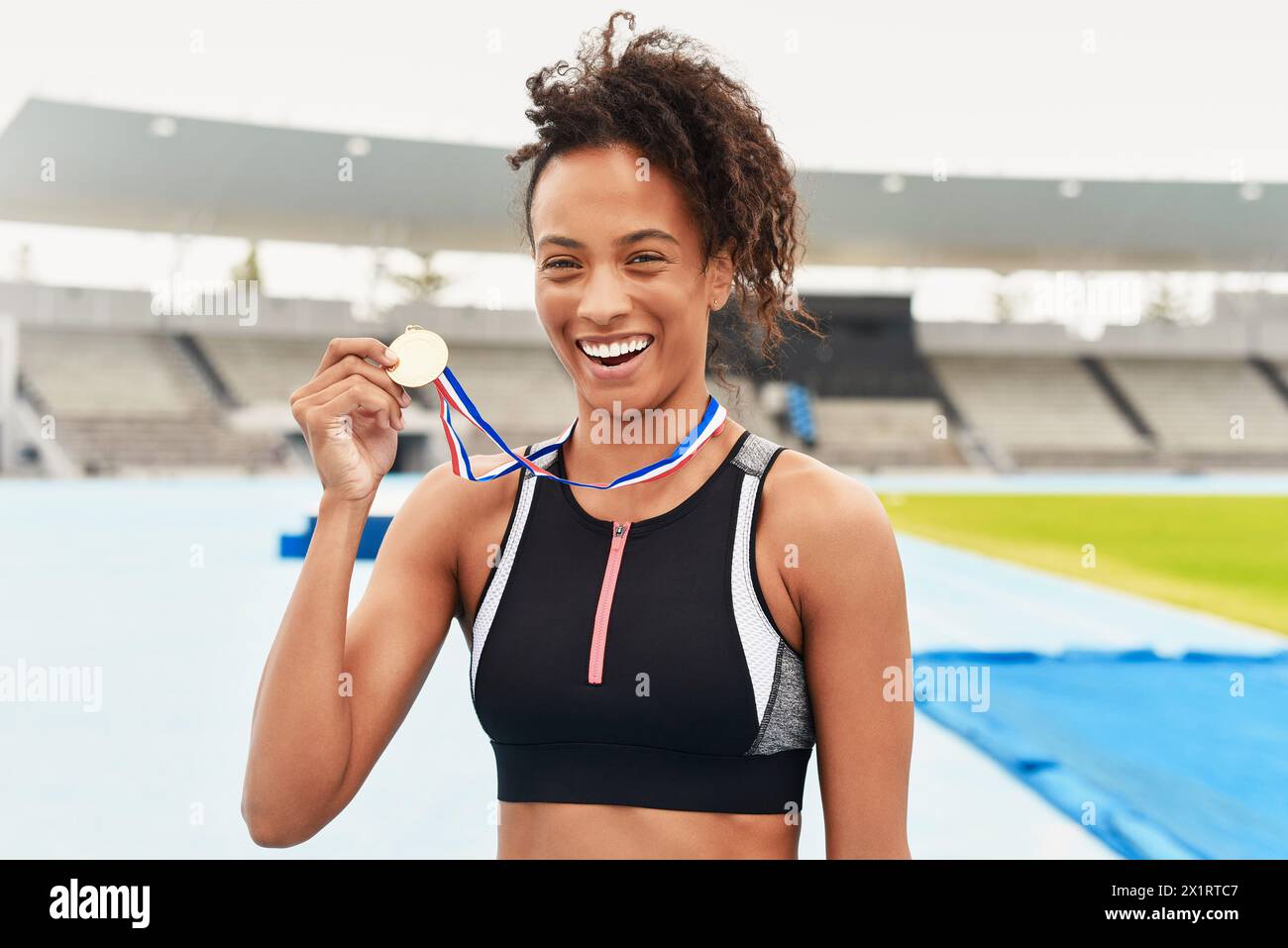 Portrait, winner and athlete with gold medal, sports and stadium for ...