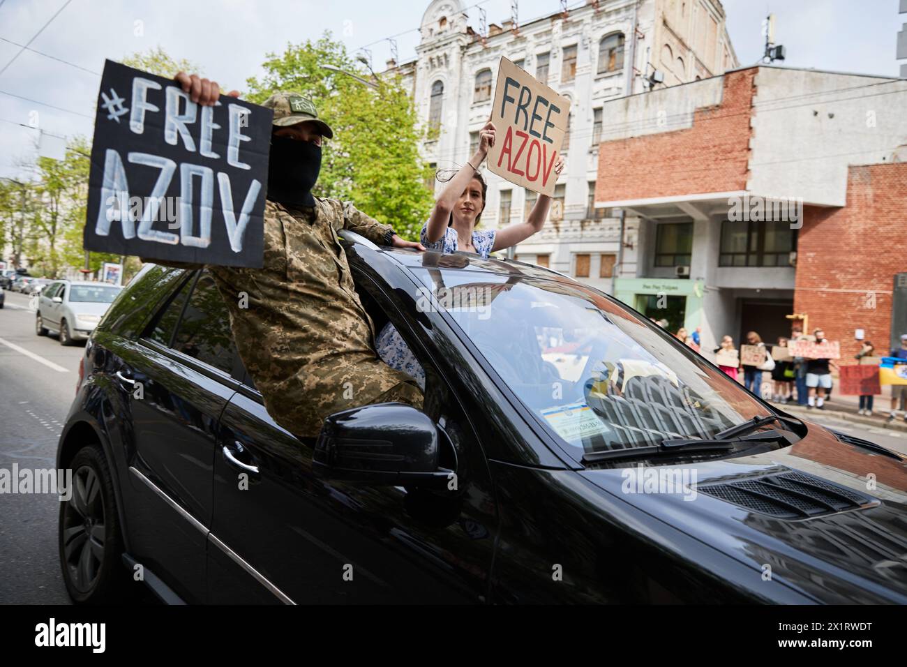 Ukrainian activists riding in a car with banners "Free Azov" in center ...