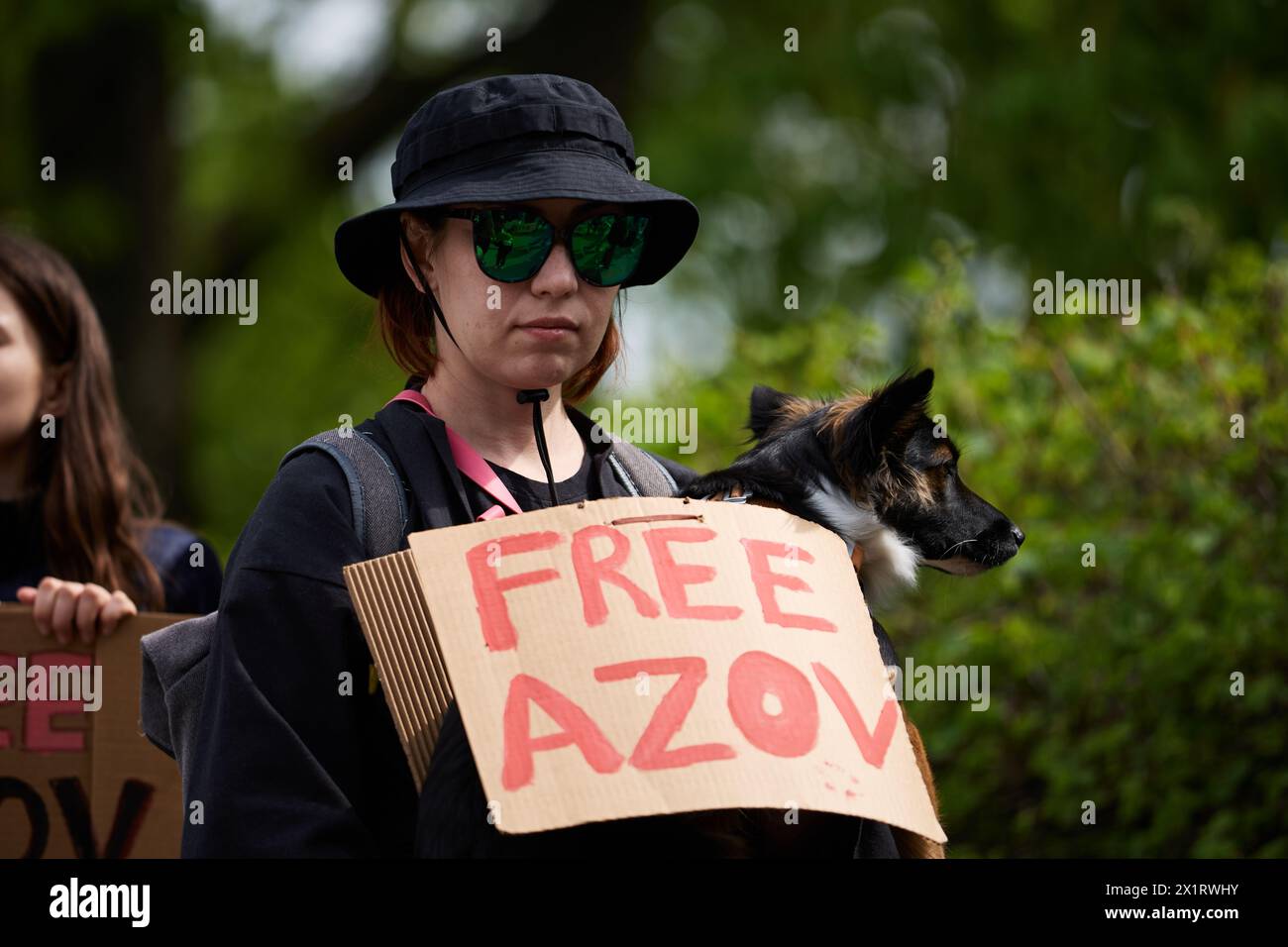 Ukrainian person posing with a sign "Free Azov" on a public ...