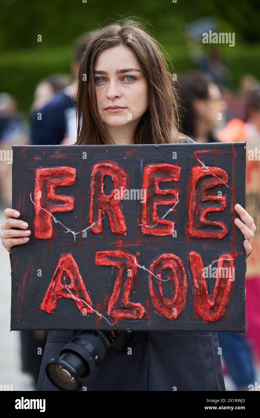 Cute Ukrainian girl posing with a banner "Free Azov" on a public ...