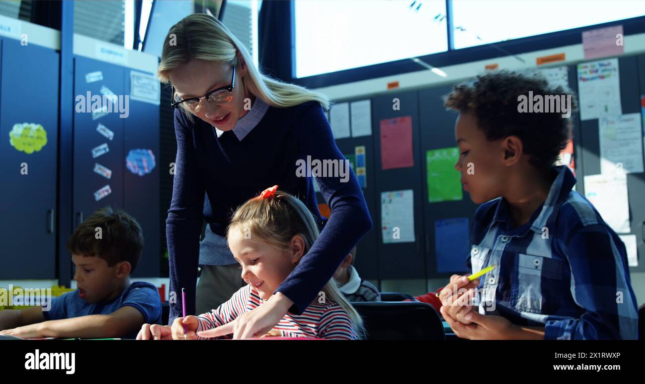 In school, young Caucasian female teacher is helping a diverse group of students Stock Photo - Alamy