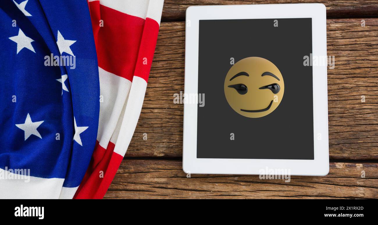 A tablet displaying winking emoji rests beside American flag Stock Photo - Alamy