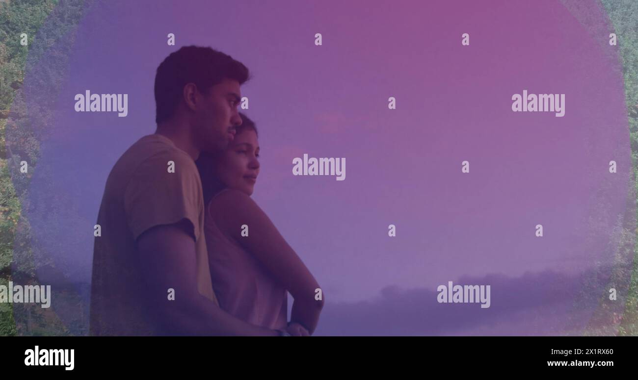 Diverse couple embracing, looking into distance Stock Photo - Alamy