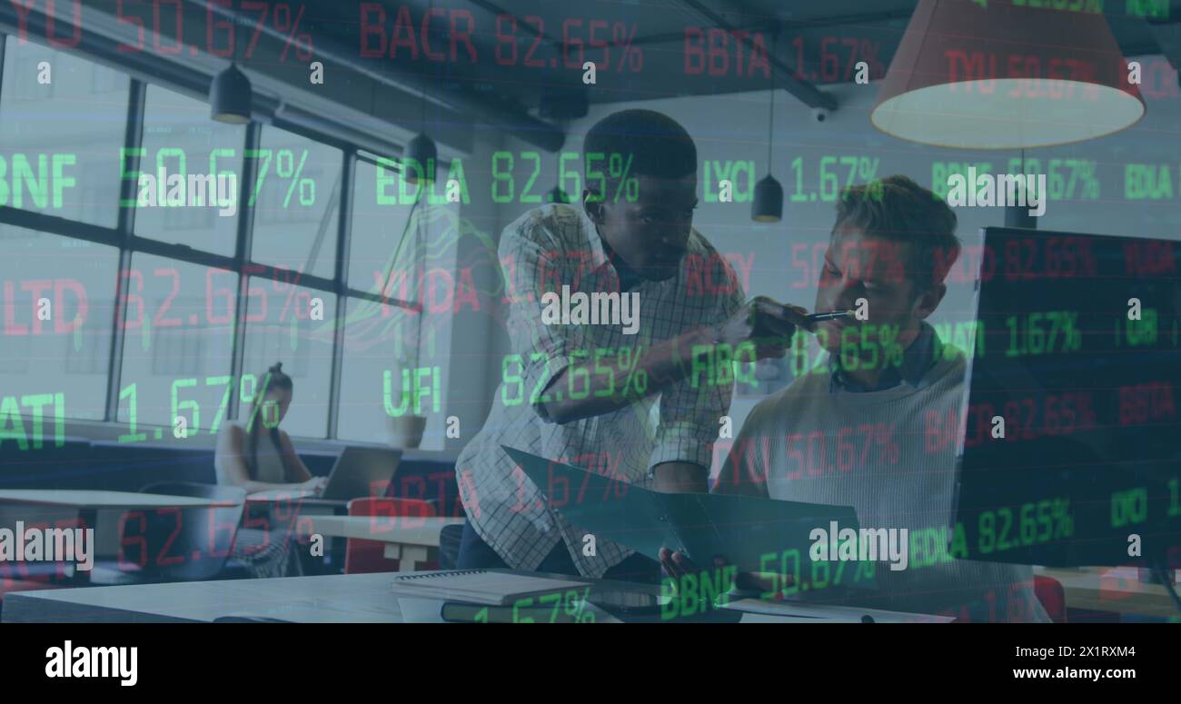 African American businessman pointing at screen, Caucasian intern ...