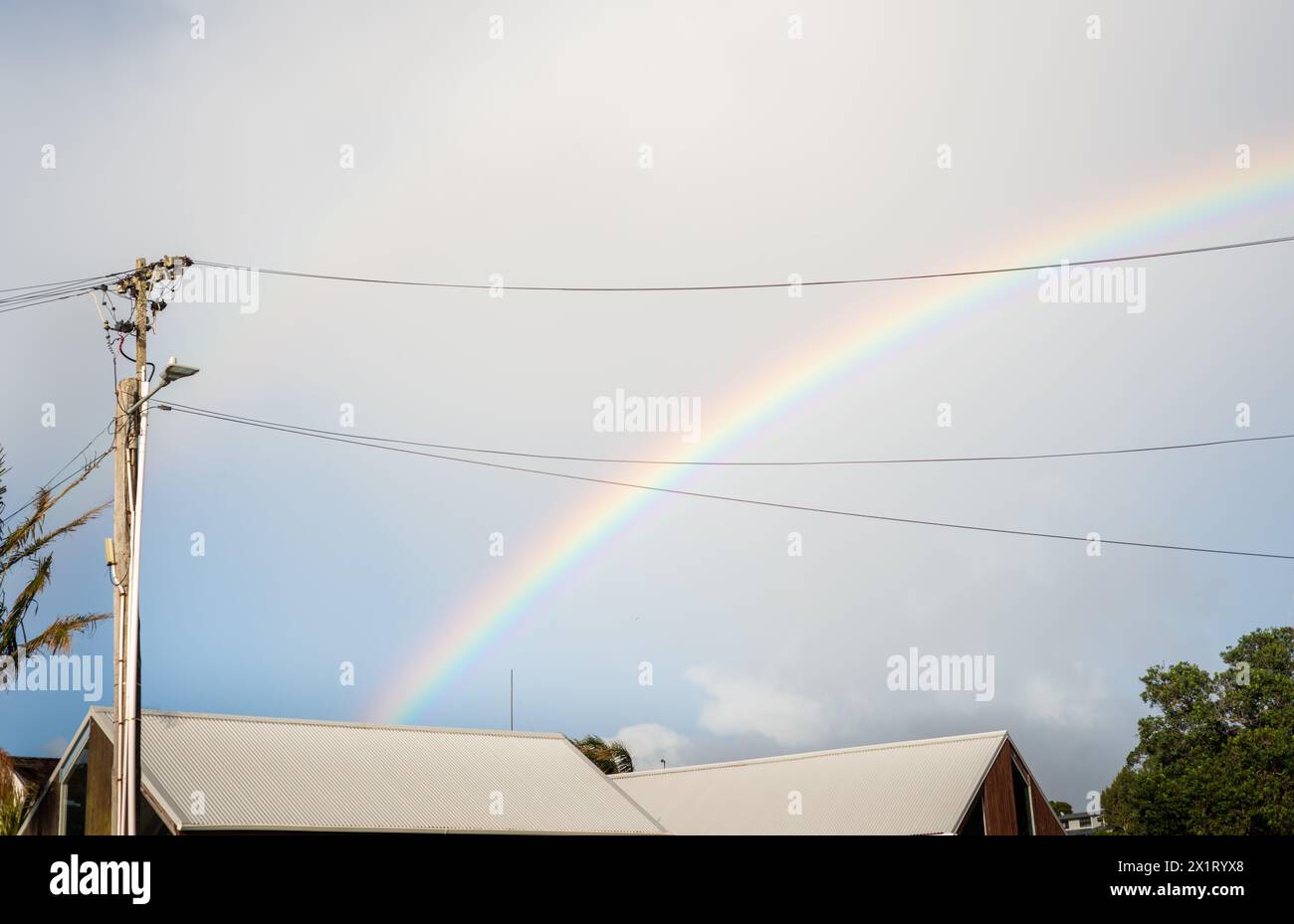 Rainbow over the houses after the rain. Auckland Stock Photo - Alamy