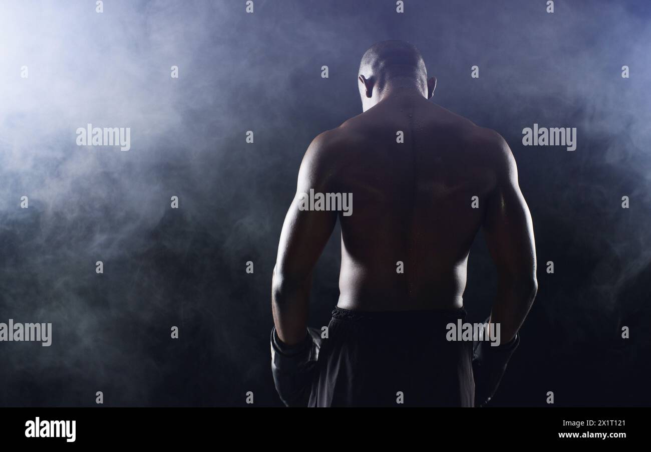 Man, boxer and back of fighter athlete on black background in studio ...