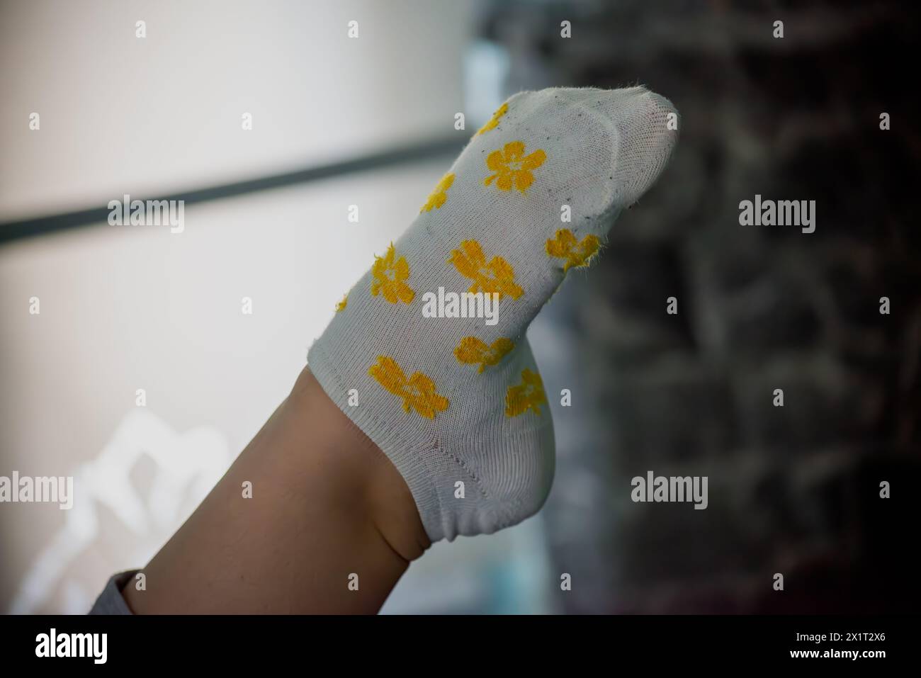 A stylish display as the woman's foot is adorned with cozy socks ...