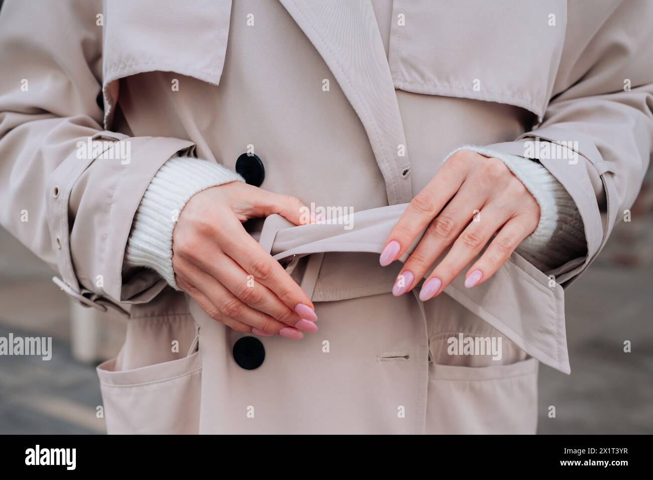 Urban street style fancy details of a beige women's trench coat with ...
