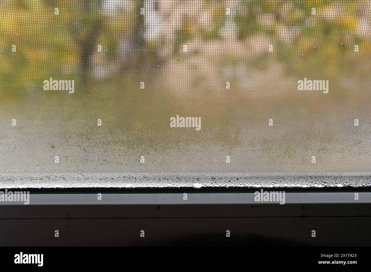 a fogged metal-plastic window. wet glass due to humidity Stock Photo ...