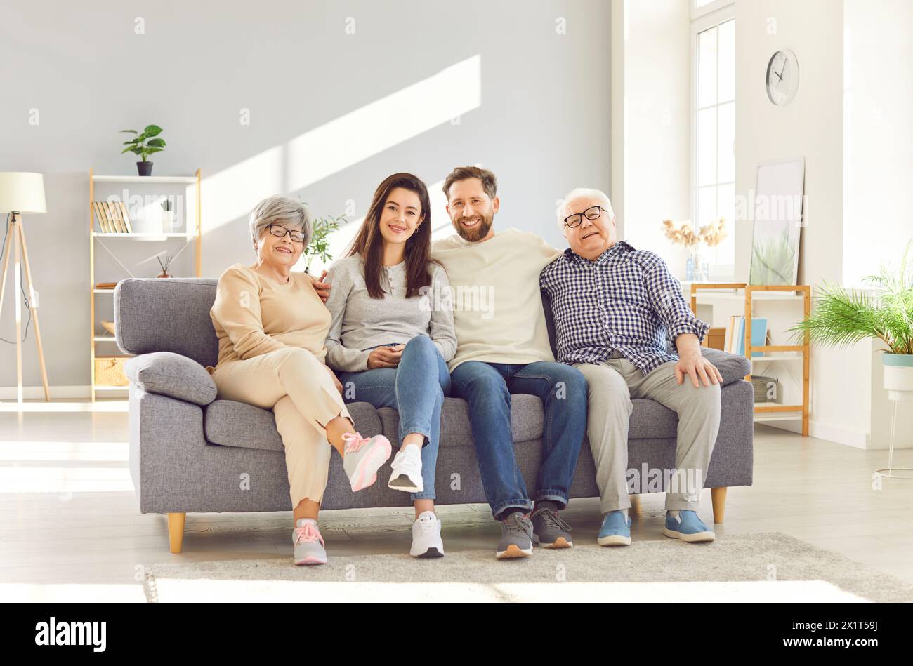Big family old parents adult children seated side by side on sofa ...