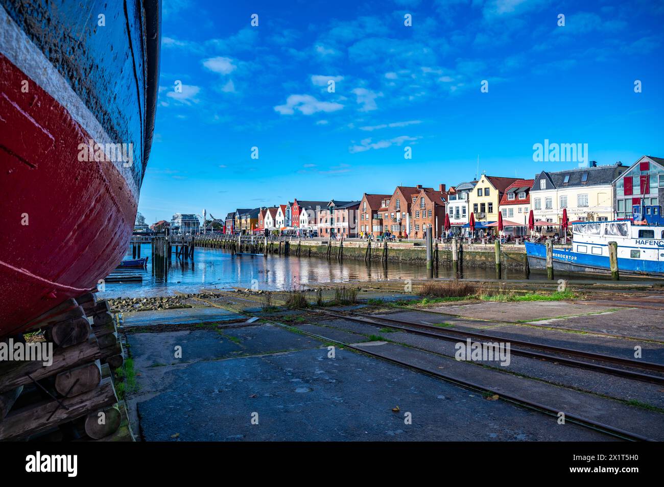Husum harbor district during autumn with clear sky and lots of tourist ...