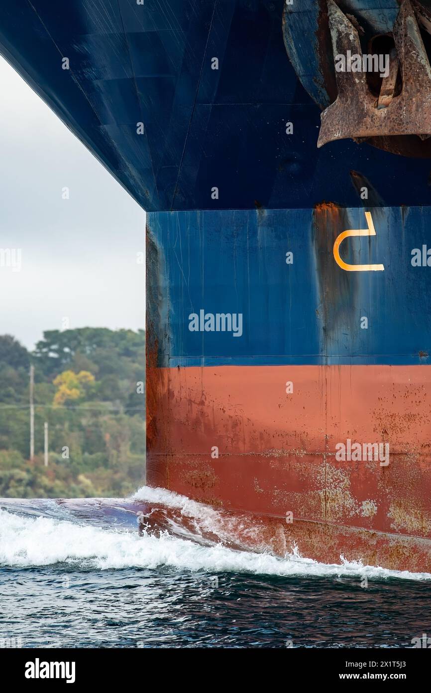Big blue container ships bow with rusty anchors pushes a giant bow wave ...