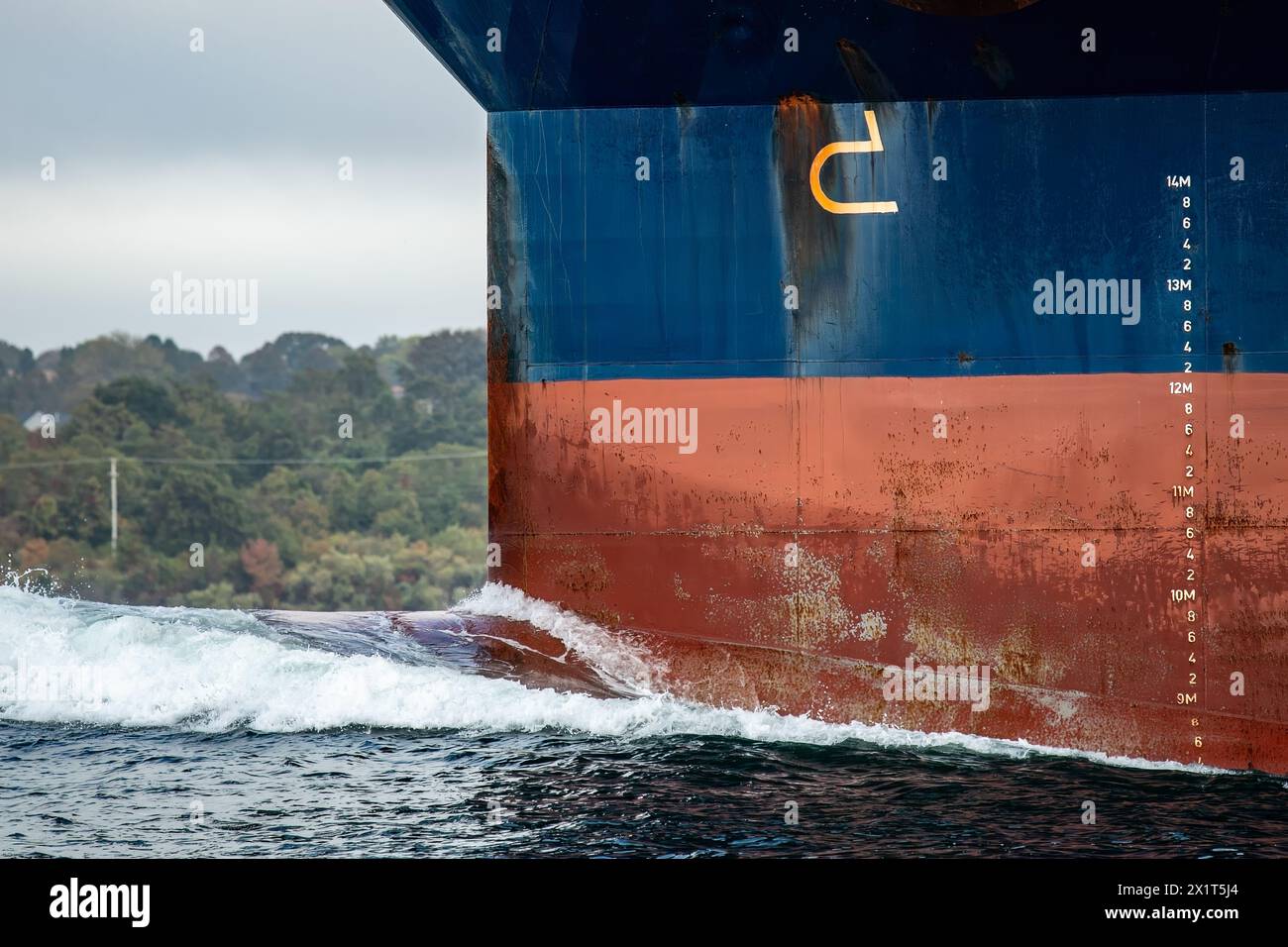 Big blue container ships bow with rusty anchors pushes a giant bow wave ...