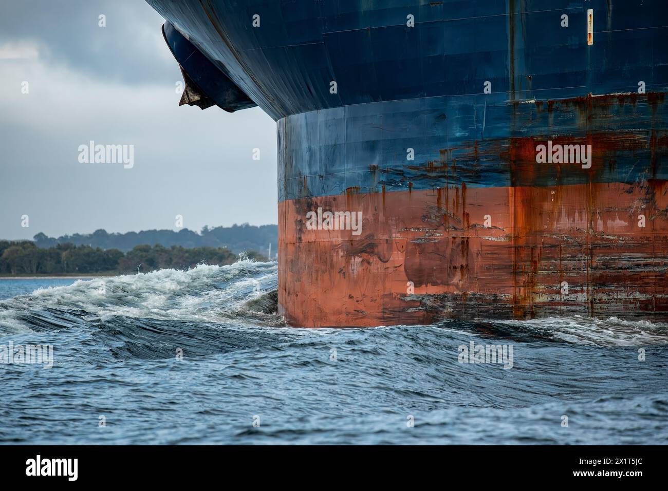 Big blue container ships bow with rusty anchors pushes a giant bow wave ...